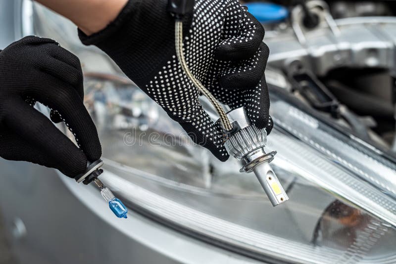 The Mechanic S Hands Hold Two Diferent Car Bulbs for Replacement in Car ...
