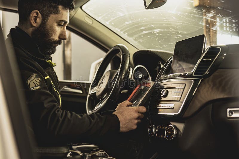 A Mechanic S Hands Use a Diagnostic Tool To Troubleshoot a Modern Car S ... A Mechanic S Hands Use a Diagnostic Tool To Troubleshoot a Modern Car S ...