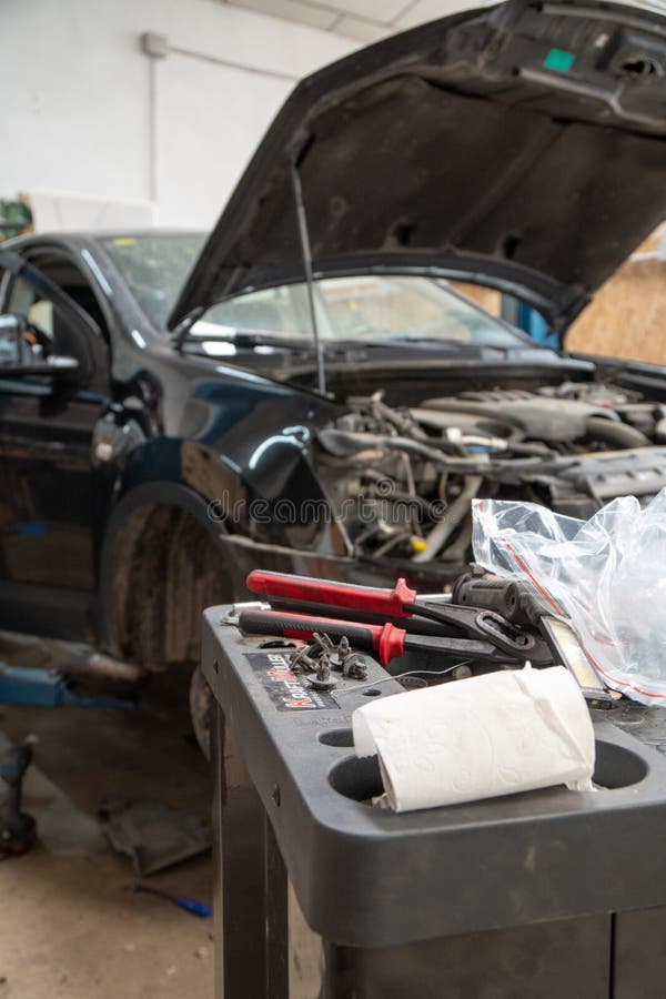 Mechanic& X27;s Table with Car Being Repaired Stock Photo - Image of ...