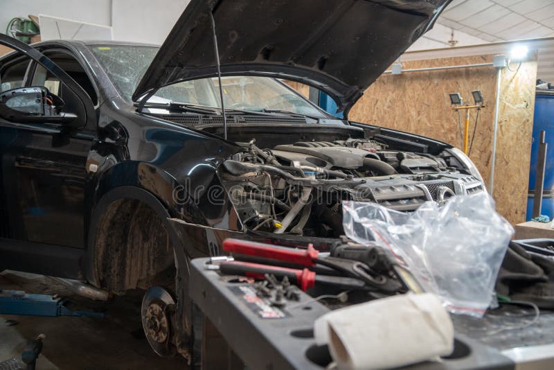 Mechanic& X27;s Table with Car Being Repaired Stock Image - Image of ...