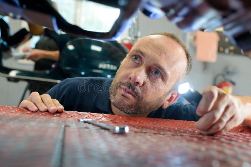 Mechanic Shining Torch Under Car Stock Photo - Image of work, shoulder ...