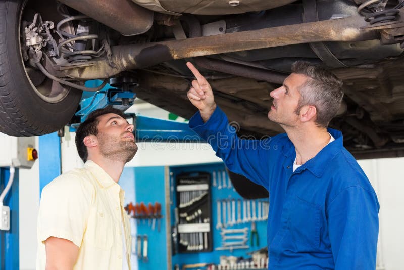Mechanic Showing Customer the Problem with Car Stock Image - Image of ...