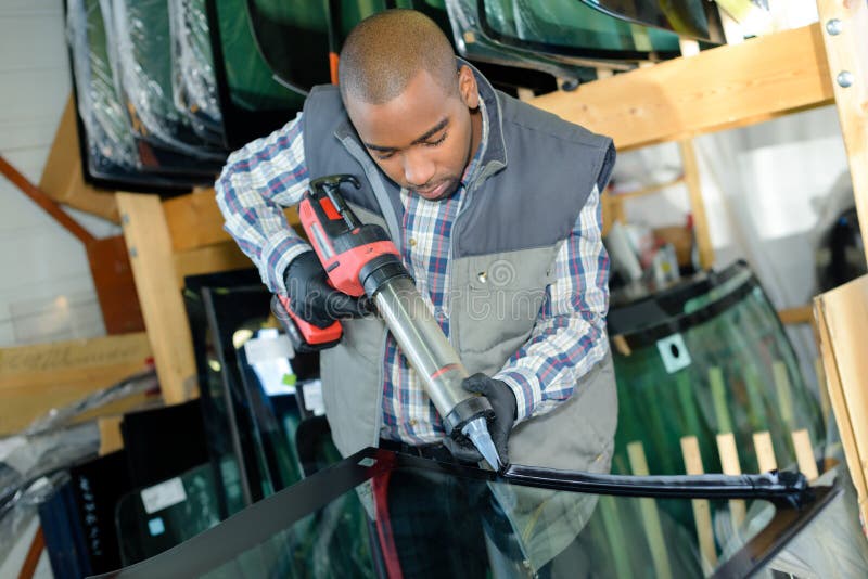 Mechanic with silicone gun stock image. Image of mechanic - 196684649