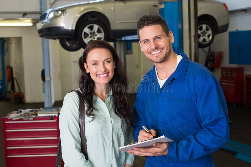 Mechanic Smiling at the Camera with Customer Stock Photo - Image of ...