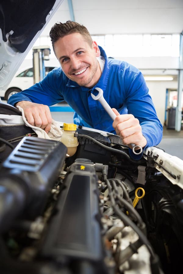 Mechanic Smiling at the Camera Fixing Engine Stock Image - Image of ...