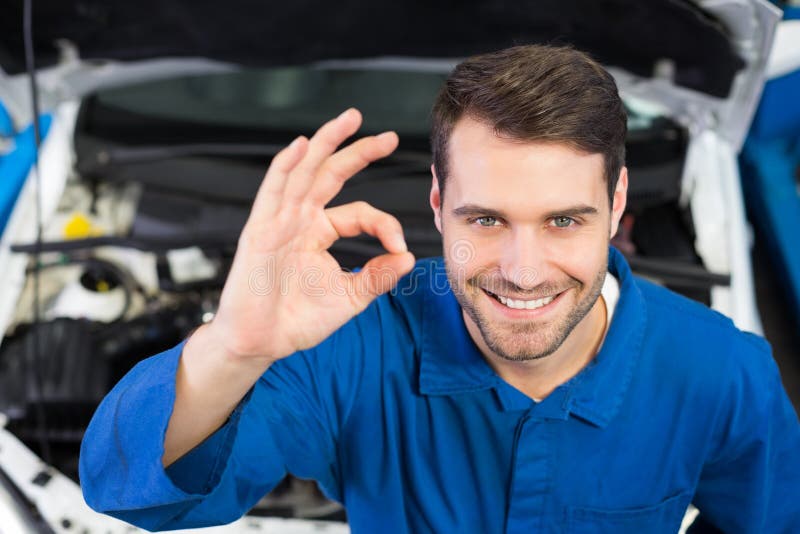 Mechanic Smiling at the Camera with Customer Stock Photo - Image of ...