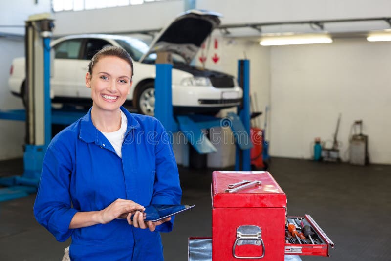 Mechanic Smiling at the Camera Using Tablet Stock Photo - Image of ...