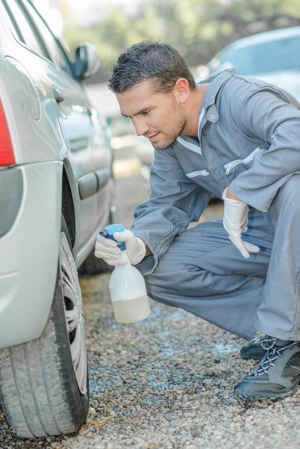 Mechanic Spraying the Wheel Stock Photo - Image of liquid, machinist ...