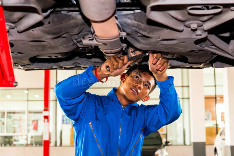 Mechanic Standing and Fixing Under a Lifted Car with Copy Space Stock ...