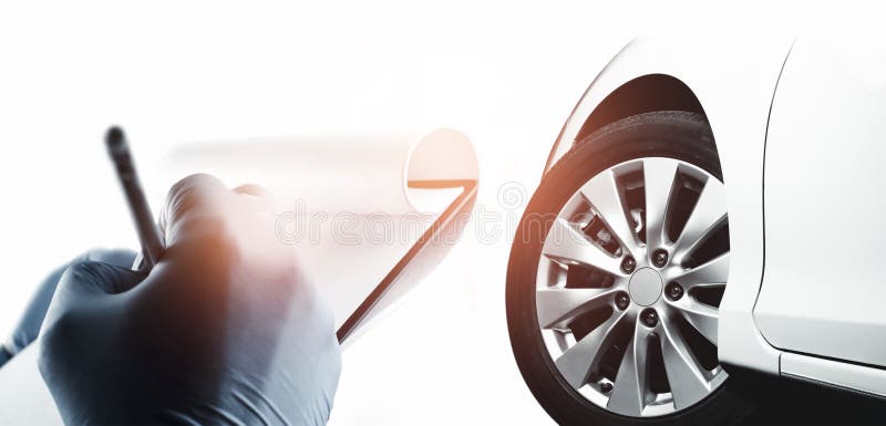 The Mechanic is Taking Notes on Paper for Analyzing the Car Problems ...