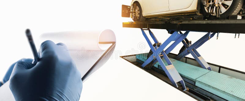 The Mechanic is Taking Notes on Paper for Analyzing the Car Problems of ...