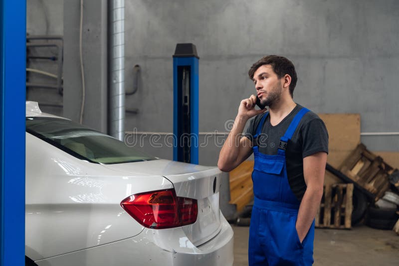 Customer Talking on the Smartphone in a Car Service Stock Image - Image ...