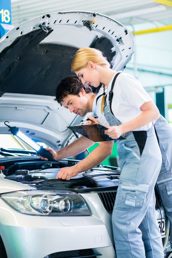 Mechanic Team Working in Car Workshop Stock Image - Image of team ...