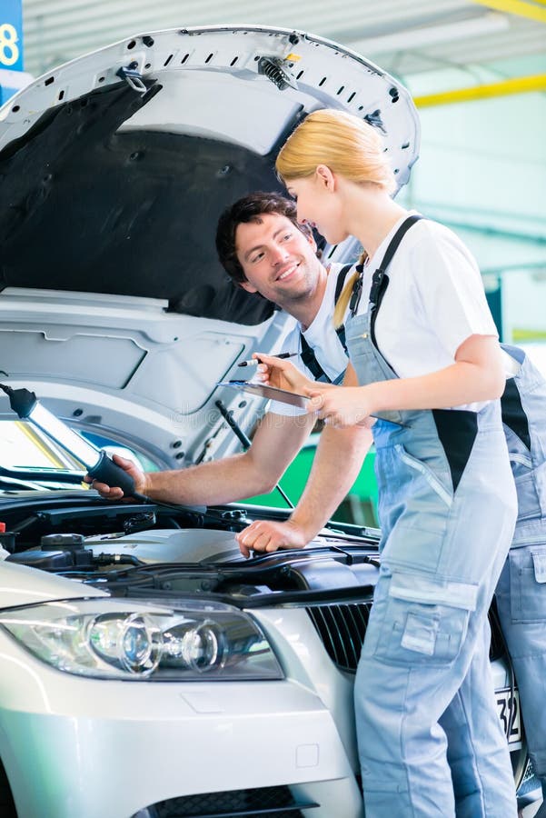 Mechanic Team Working in Car Workshop Stock Image - Image of team ...