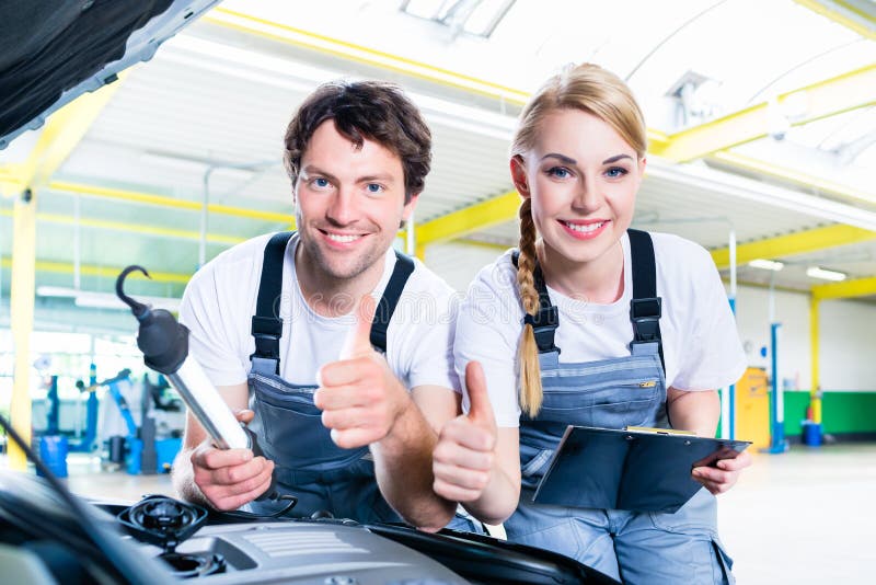 Mechanic Team Working in Car Workshop Stock Image - Image of team ...