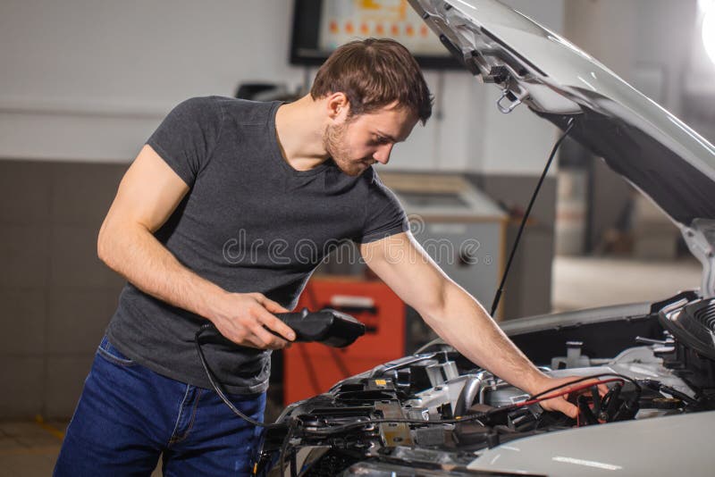 Mechanic Testing Electrical System on Automobile Stock Image - Image of ...