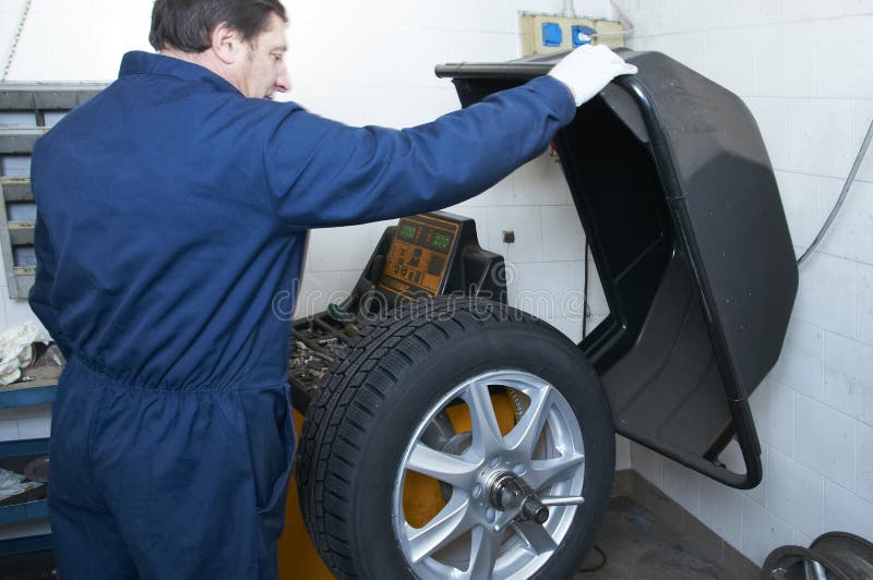 Mechanic and tire stock image. Image of technician, transport - 23223761