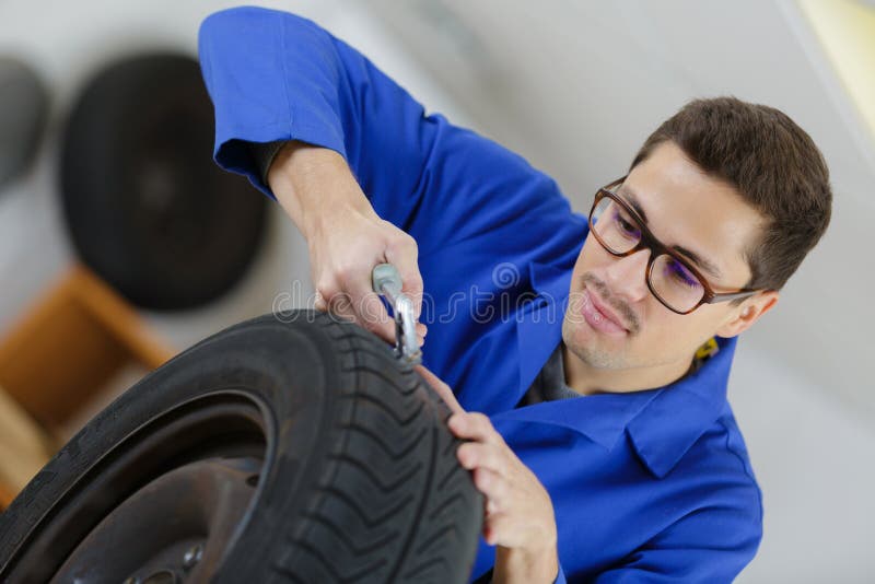 Mechanic with Tool Changing Tyre Car Stock Image - Image of engine ...
