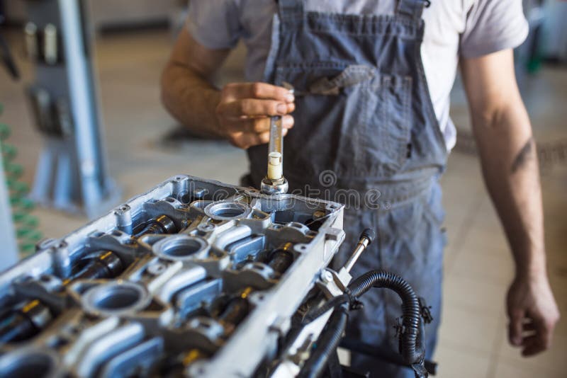 Mechanic with a Tool in His Hands Repairing the Motor of the Machine ...