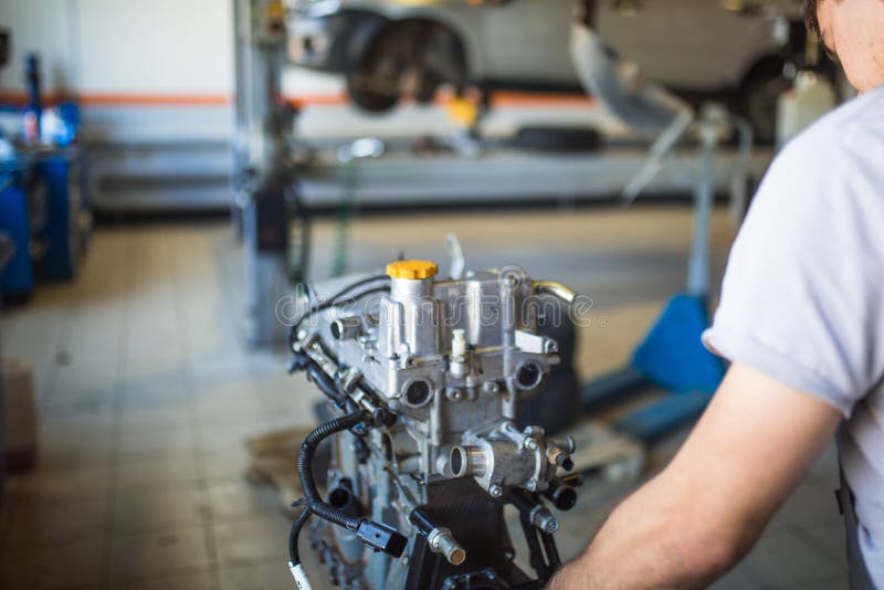 Mechanic with a Tool in His Hands Repairing the Motor of the Machine ...