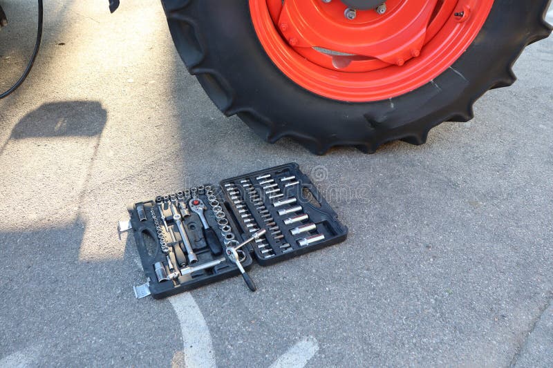 Mechanic Tools Next To a Large Tractor Tire, Ready for Various Tasks ...