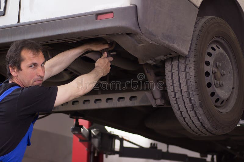 Mechanic uses jackscrew stock image. Image of assistant - 125088979