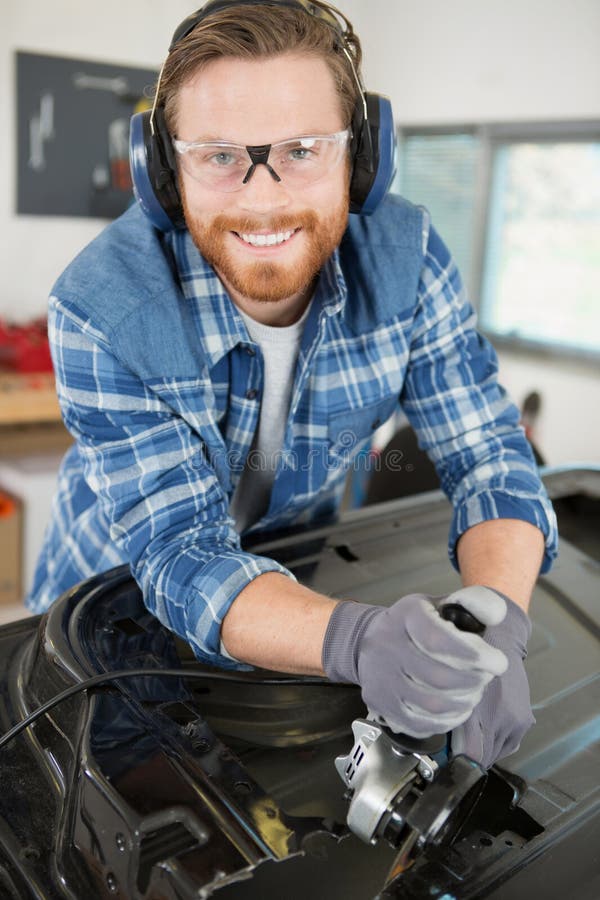 Mechanic Using Angle Grinder Stock Photo - Image of engine, smile ...