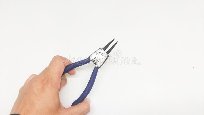 A Mechanic is Using a Blue-handled Circlip Pliers To Remove a Piston ...