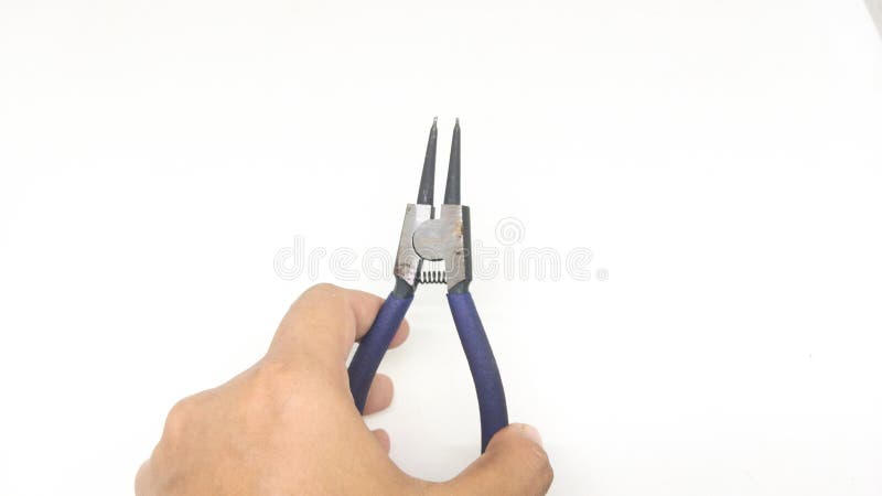 A Mechanic is Using a Blue-handled Circlip Pliers To Remove a Piston ...