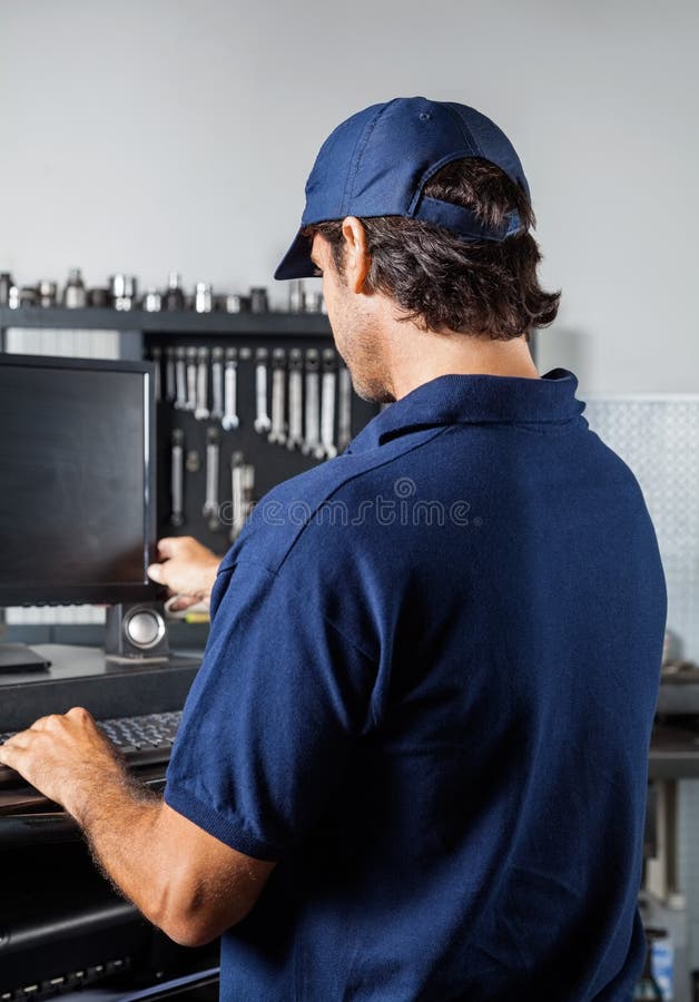 Mechanic Using Computer in Garage Stock Photo - Image of adult, auto ...