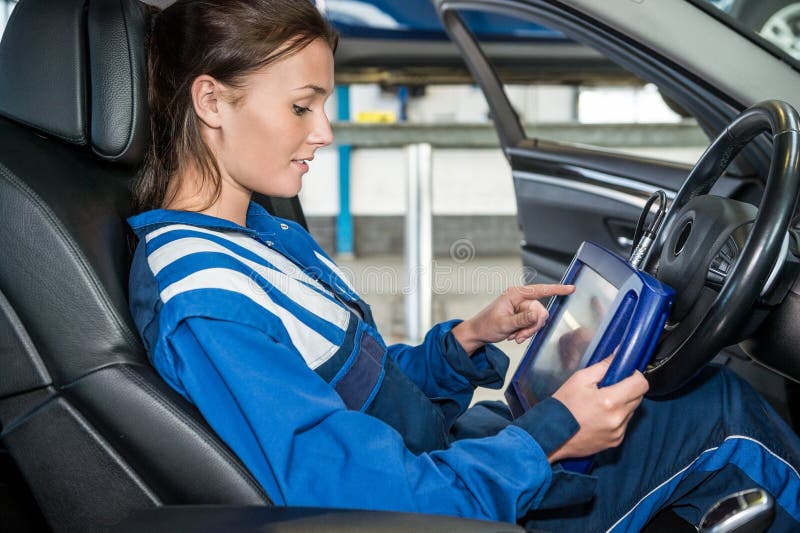 Mechanic Using Digital Tablet in Car at Garage Stock Photo - Image of ...