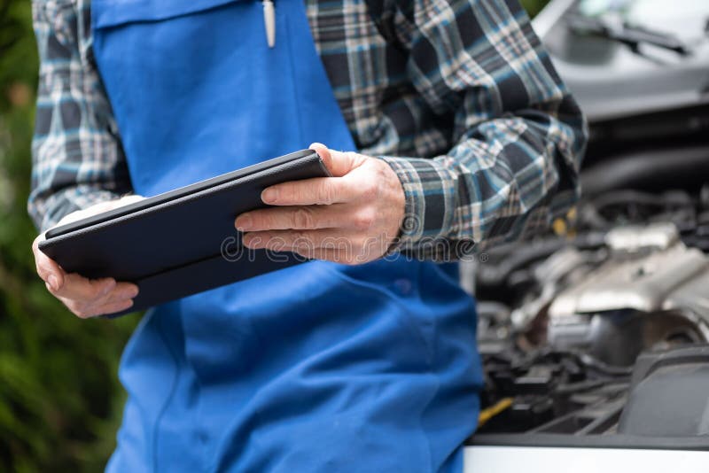 Mechanic Using Digital Tablet for Checking Car Engine Stock Photo ...