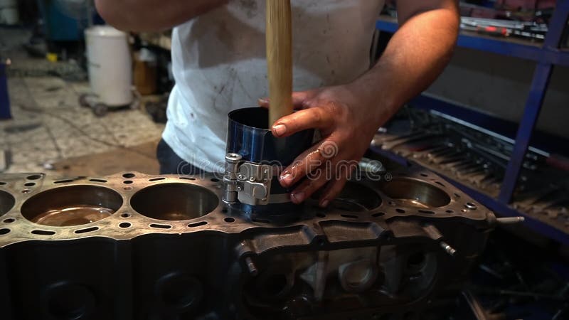 Mechanic Using Hammer To Install Engine Part Stock Video - Video of ...