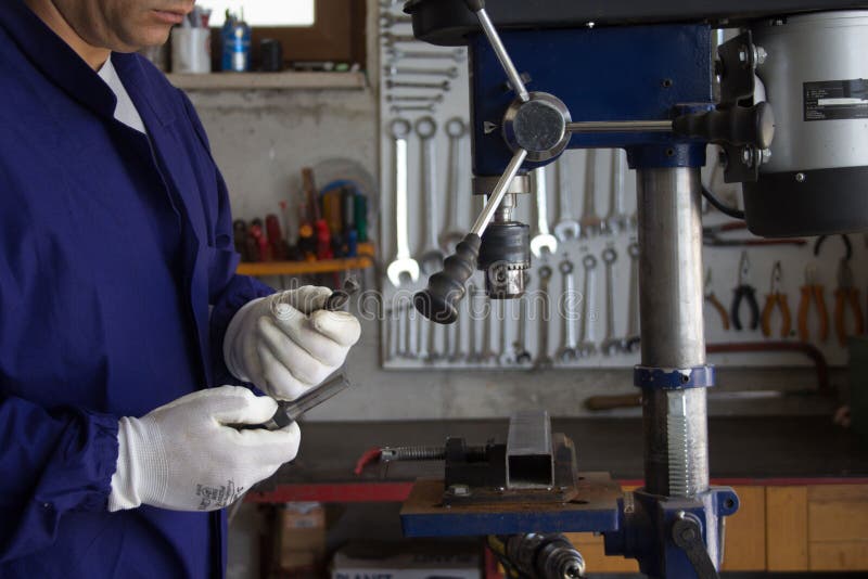 Mechanic Using Industrial Machine in the Workshop Stock Photo - Image ...