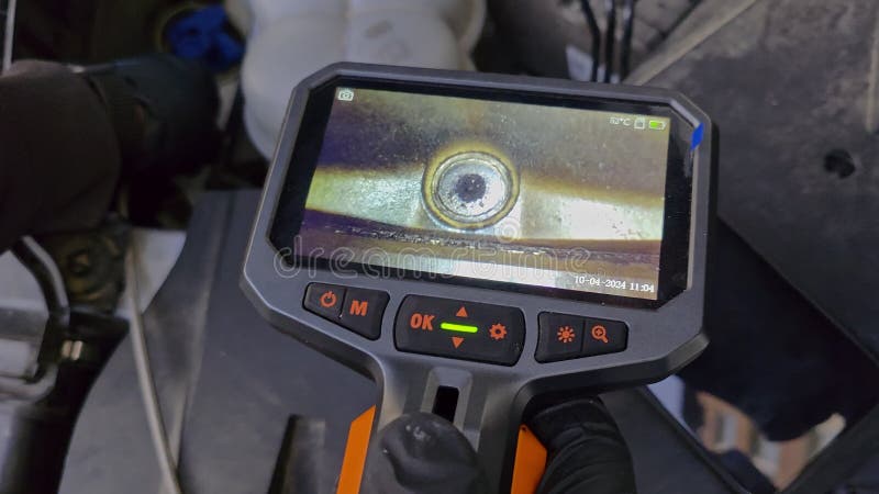 Mechanic Using Inspection Camera To Examine Internal Engine Components ...