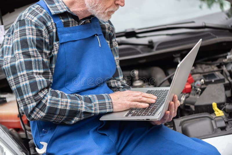 Mechanic Using Laptop for Checking Car Engine Stock Photo - Image of ...