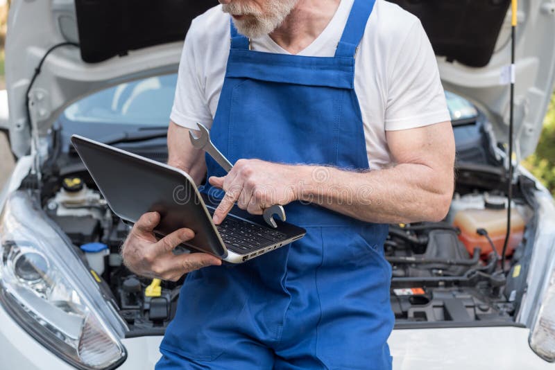 Mechanic Using Laptop for Checking Car Engine Stock Image - Image of ...