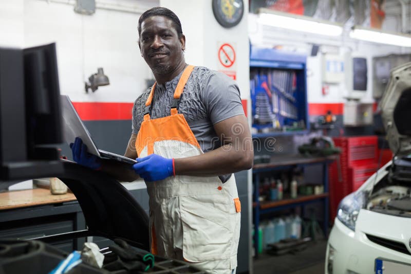 Mechanic Using a Laptop To Work in Service Stock Photo - Image of ...