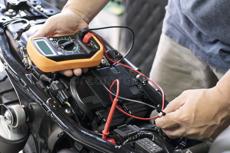 Mechanic Using Multimeter To Check the Voltage Level on Motorcycle ...