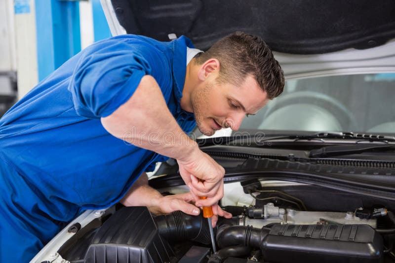 Mechanic Using Screwdriver on Engine Stock Photo - Image of indoors ...