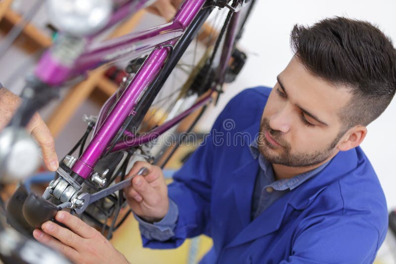 Mechanic Using Spanner on Bicycle Stock Photo - Image of maintenance ...