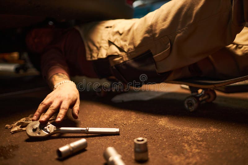 Mechanic Using Tool To Repair the Car Stock Photo - Image of ground ...