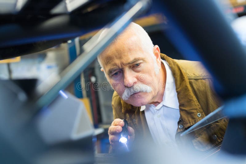 Mechanic Using Torch To Inspect Vehicle Stock Image - Image of ...