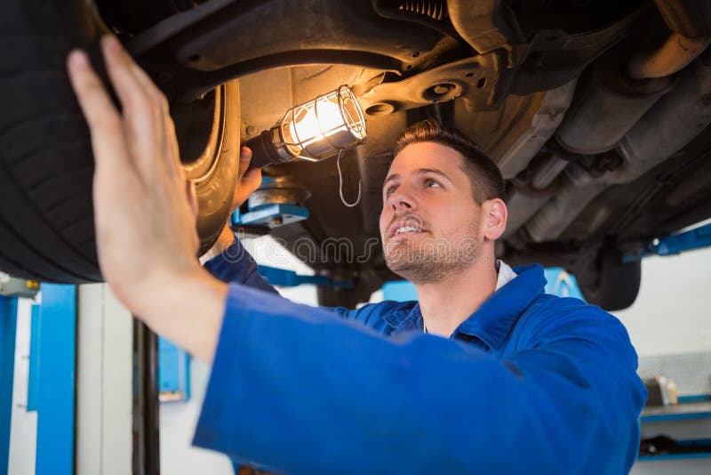 Mechanic Using Torch To Look Under Car Stock Photos - Free & Royalty ...