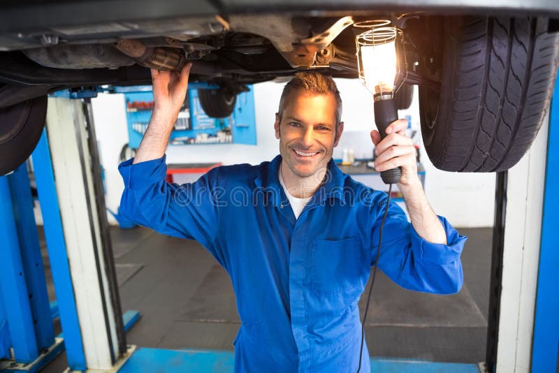 Mechanic Shining Torch Under Car Stock Photo - Image of occupation ...