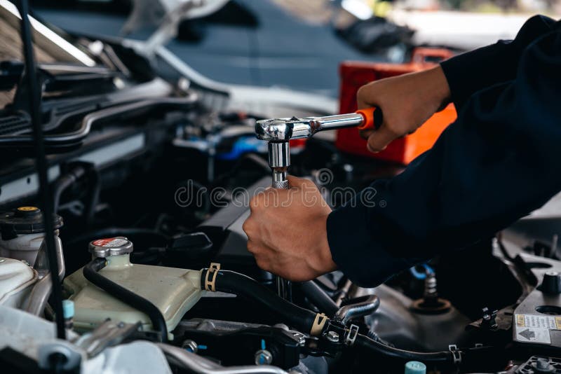 Mechanic Using Wrench while Working on Car Engine at Garage Workshop ...