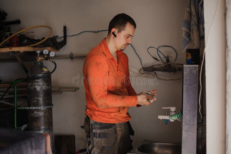 The Mechanic Washes His Hands after Car Repair. Worker Washes His Hands ...