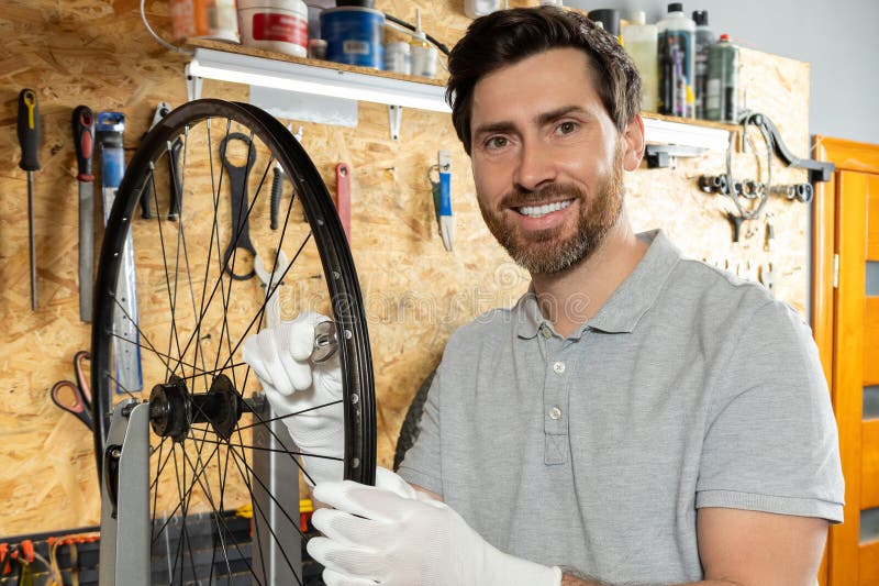 Mechanic in White Gloves Lifting Wheel Stock Photo - Image of gloves ...