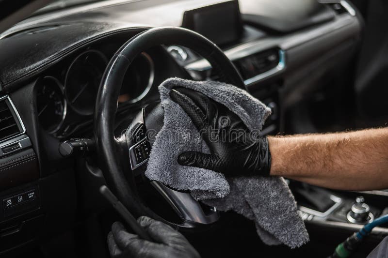 A Mechanic Wipes the Steering Wheel of a Car with a Microfiber Cloth ...