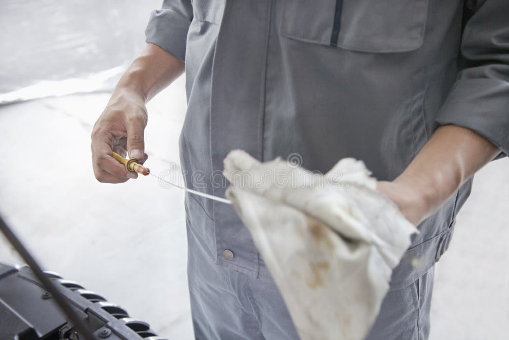 Mechanic Wiping Down Dipstick Stock Image - Image of ethnicity, grey ...